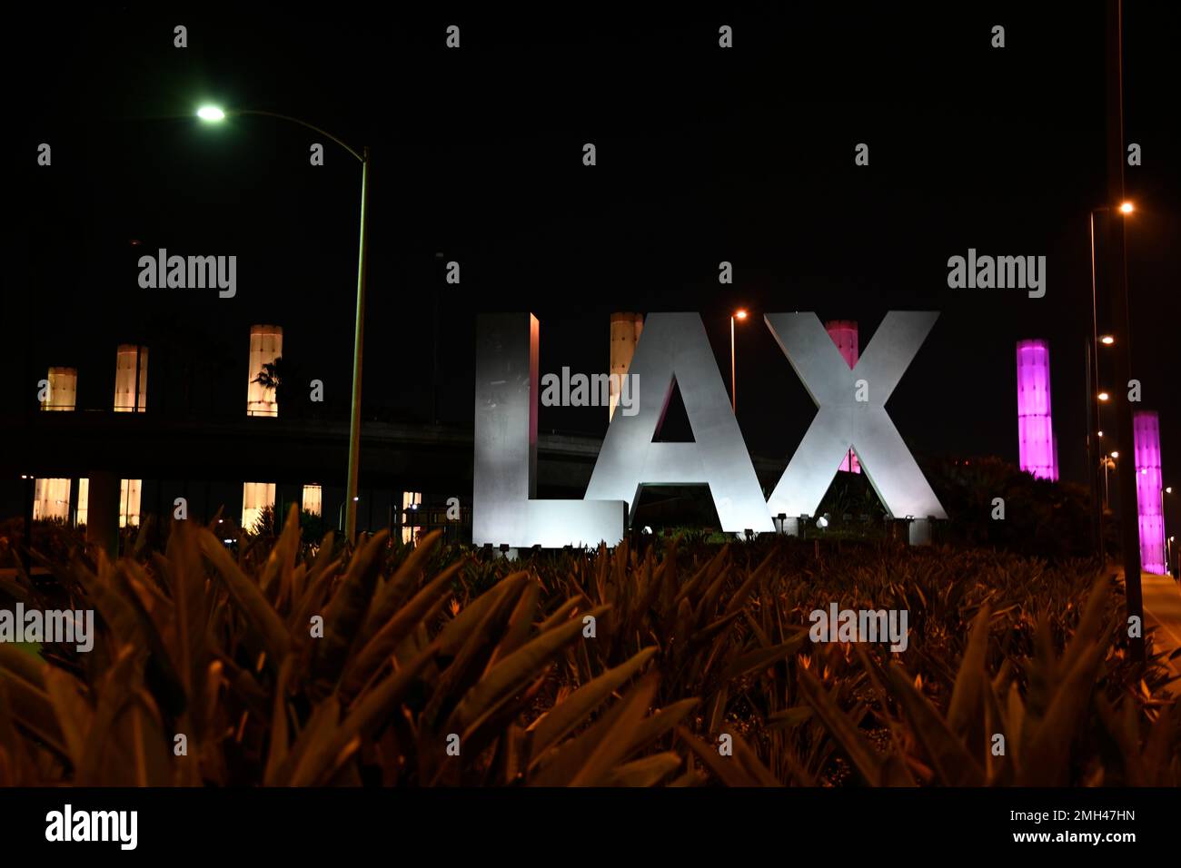 Lights of purple and gold illuminate the pylons outside of LAX in ...