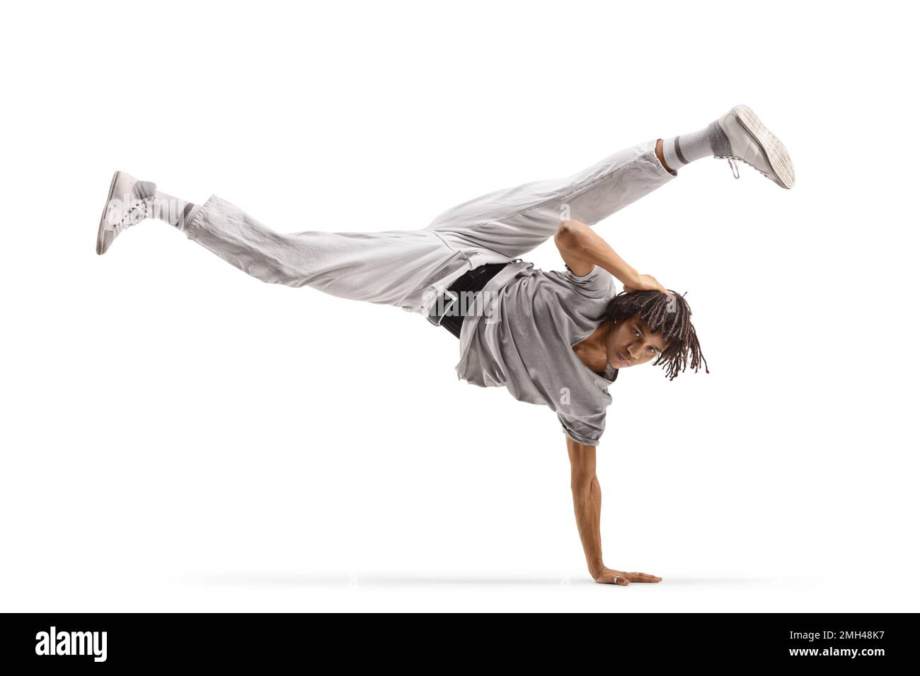 Afro american male dancer performing a handstand isolated on white ...
