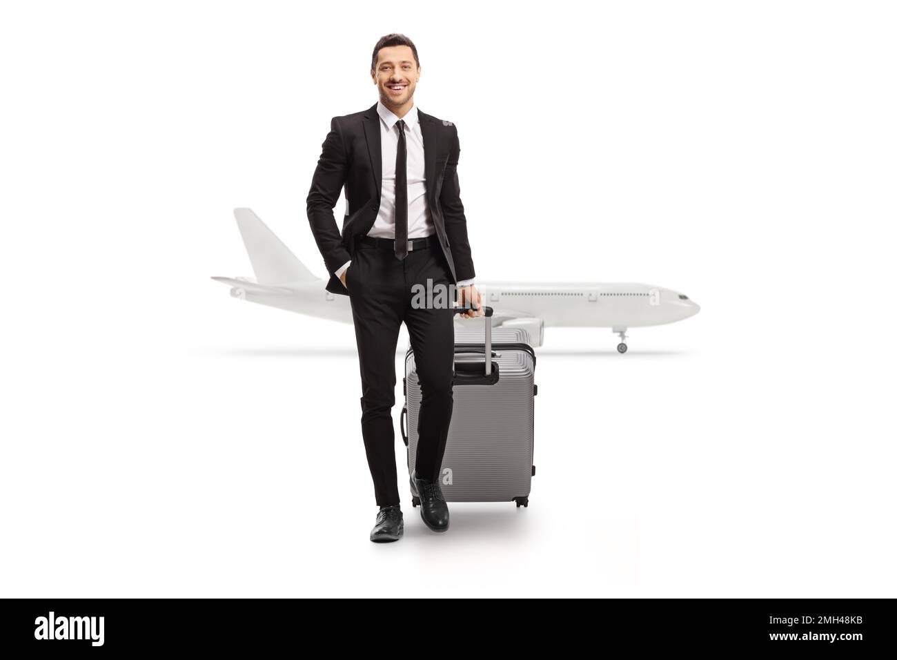 Full length portrait of a businessman getting off a plane and walking ...