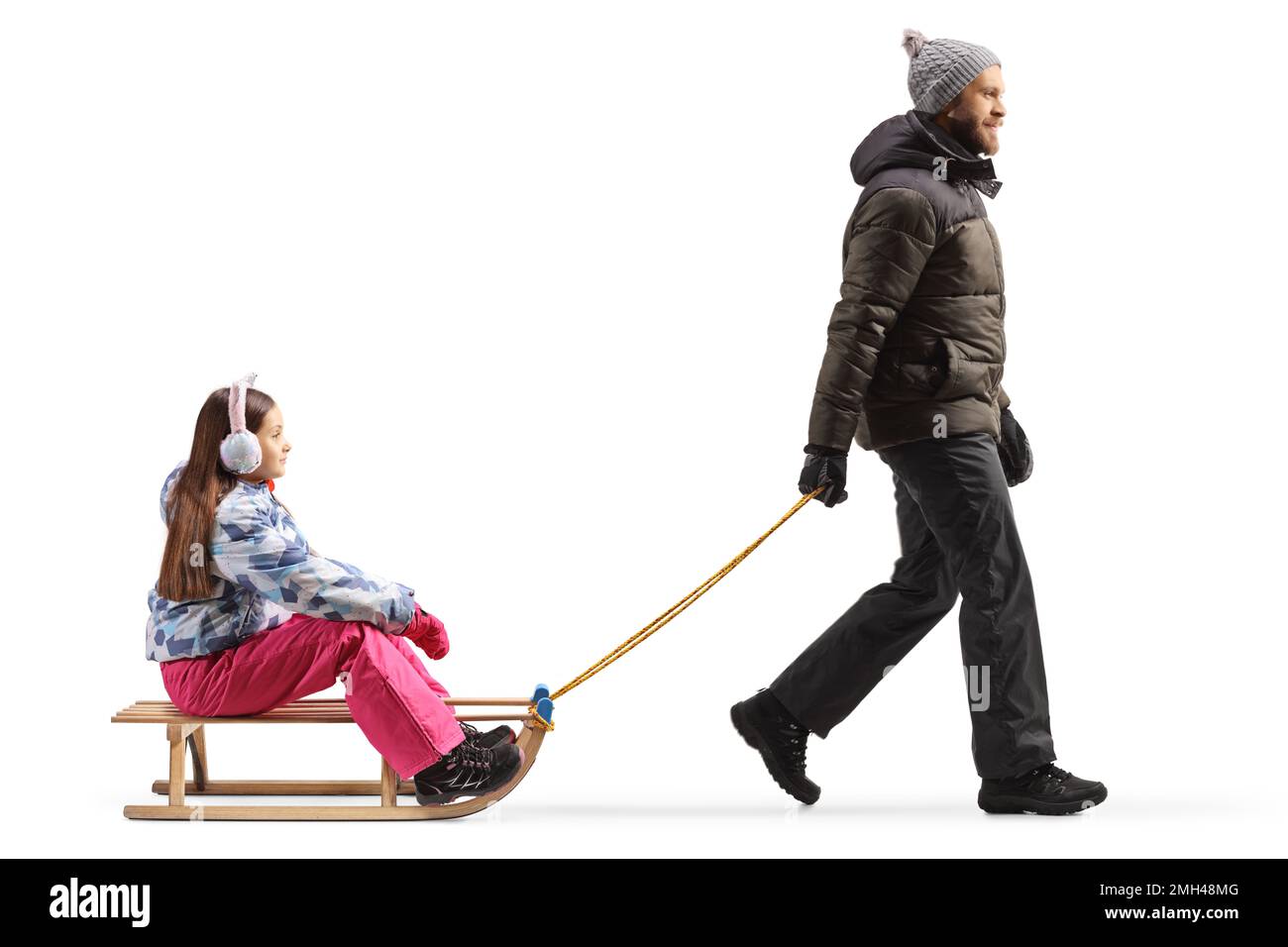 Full length profile shot of a father pulling a girl with a wooden ...