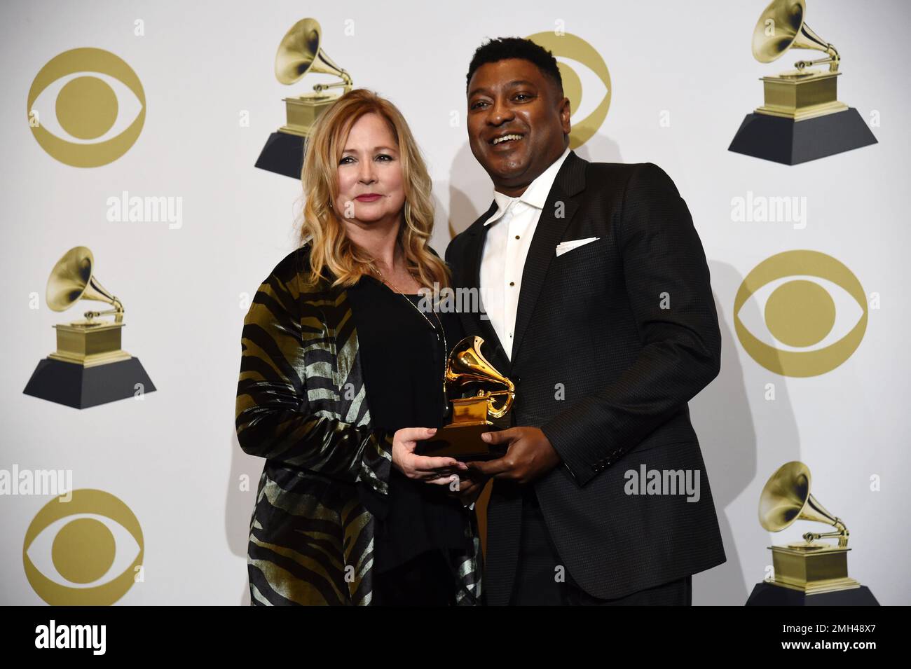 Erinn Williams, left, and Steve Pamon pose in the press room with the ...