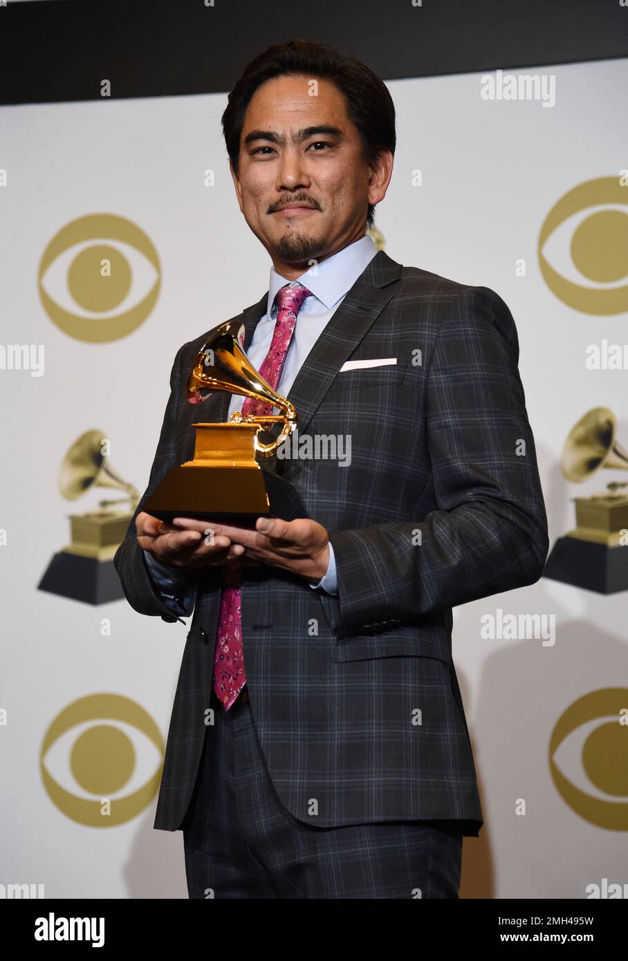 Masaki Koike poses in the press room with the award for best boxed or ...