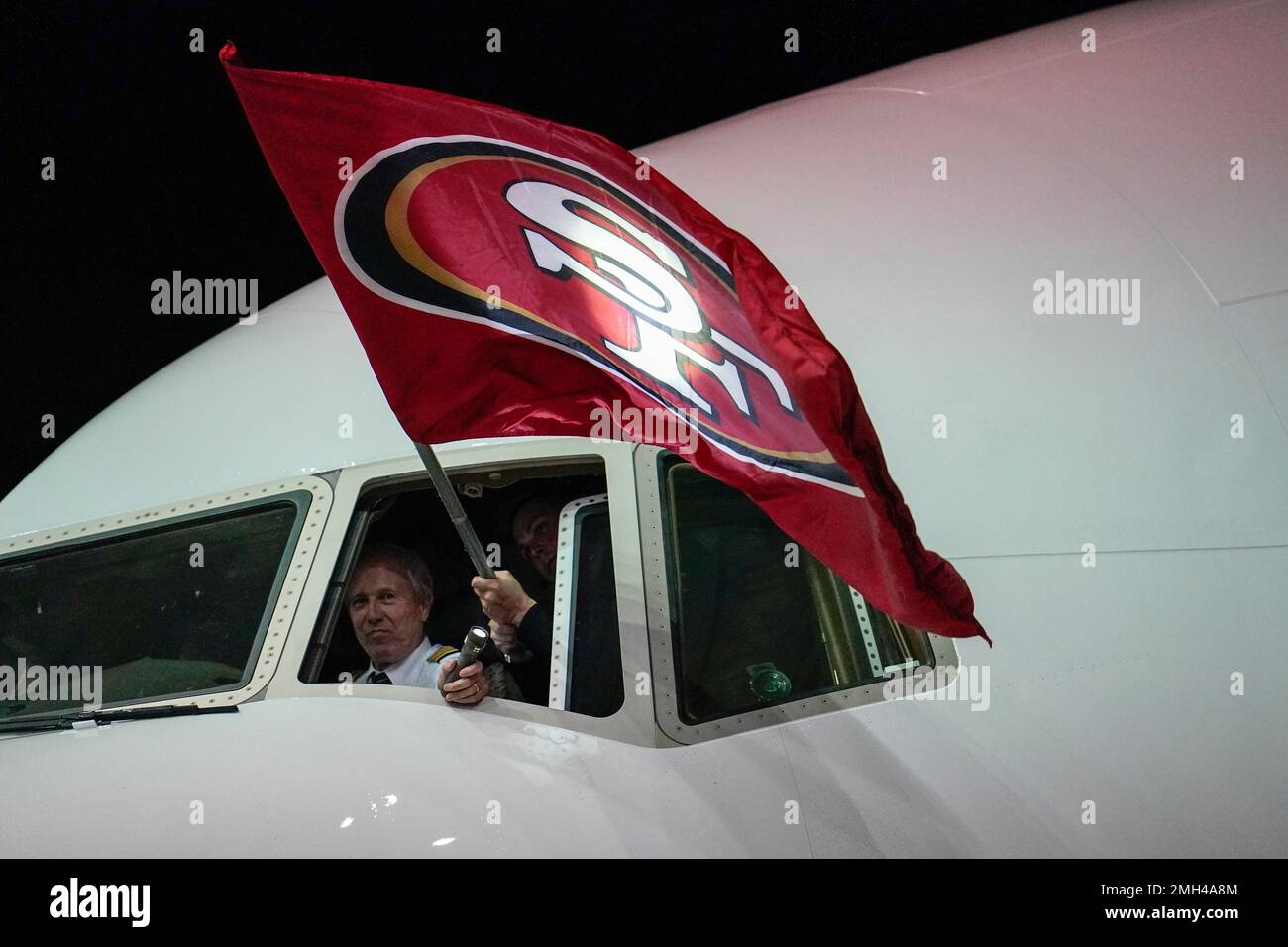 A pilot holds a flag as the San Francisco 49ers arrive for the NFL ...