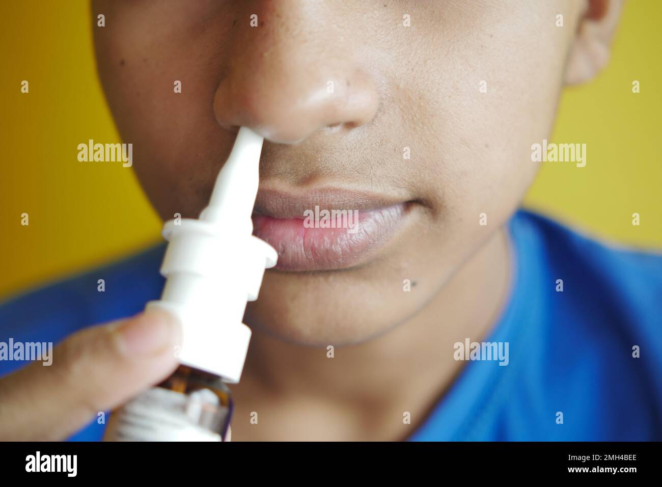 close up of sick boy using nasal medicine spray Stock Photo - Alamy