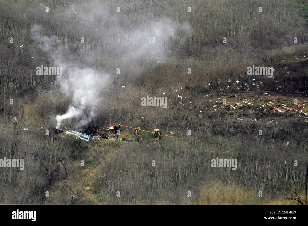 Firefighters work the scene of a helicopter crash Sunday, Jan. 26, 2020 ...