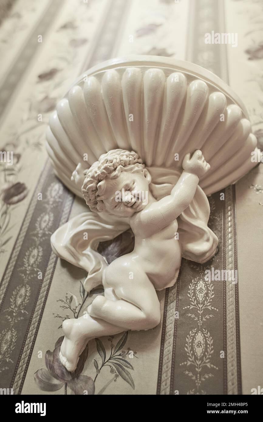 A composition wall bracket with angel support Stock Photo - Alamy