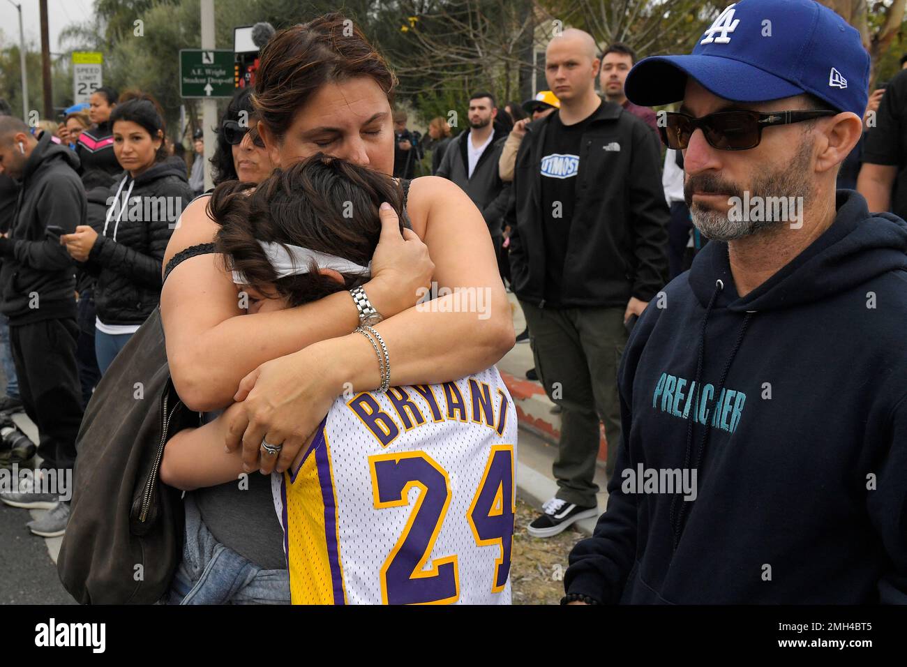 Elana Hirschman, left, hugs her son Bryan, 11, as her husband Craig ...