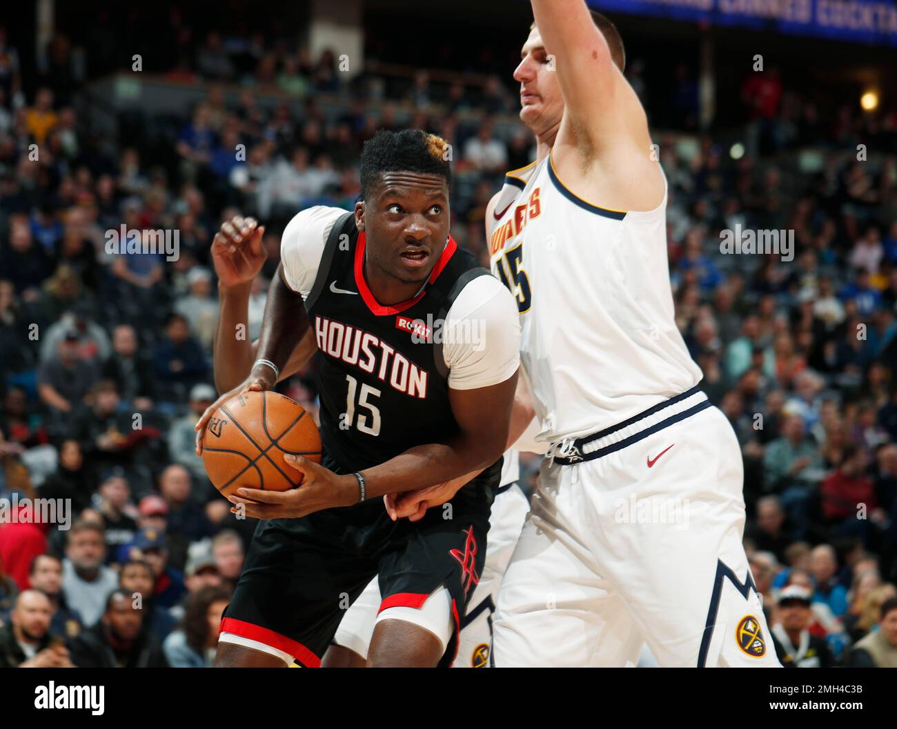 Houston Rockets center Clint Capela, left, drives to the rim as Denver ...