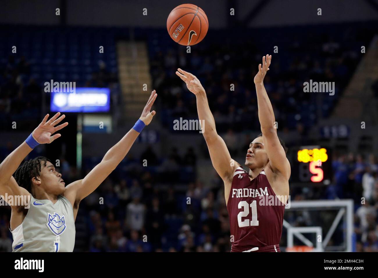 Fordham's Josh Colon (21) shoots over Saint Louis' Yuri Collins (1 ...