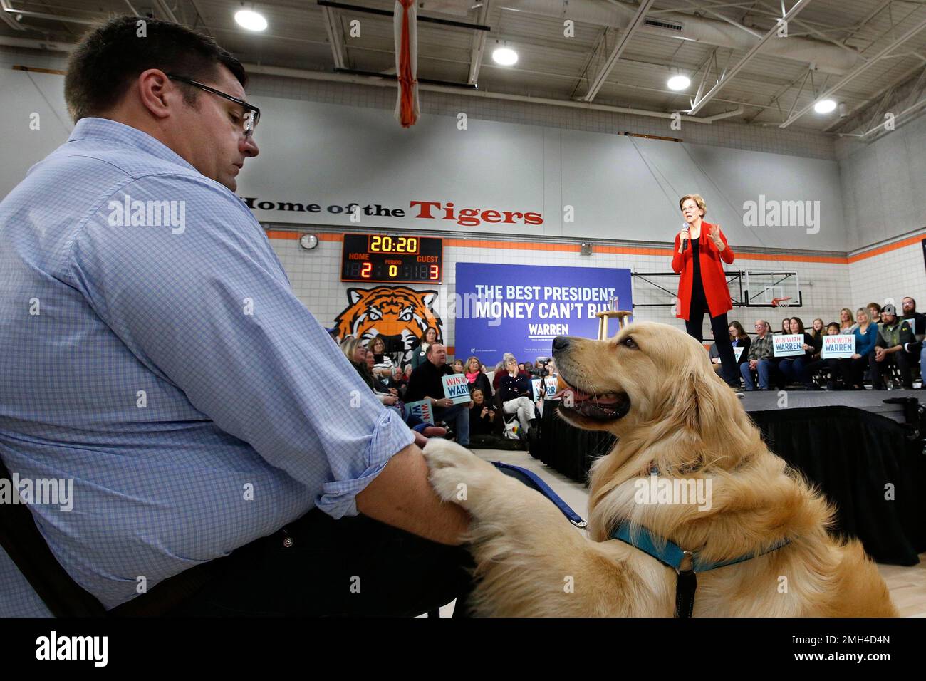 The family dog, Bailey, looks for attention from Alex Warren, left, as ...