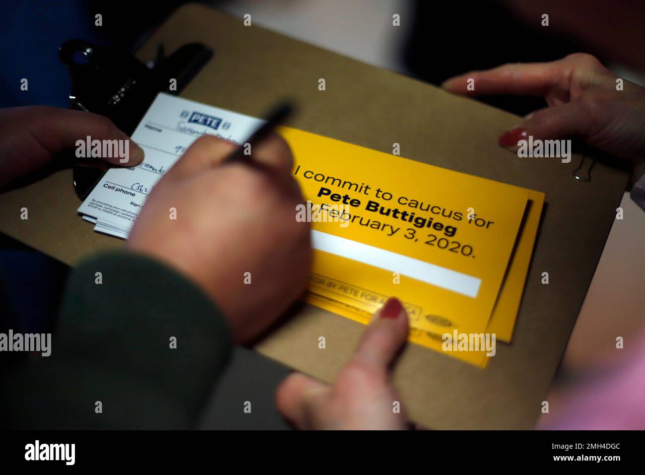 A person signs up to caucus for Democratic presidential candidate ...