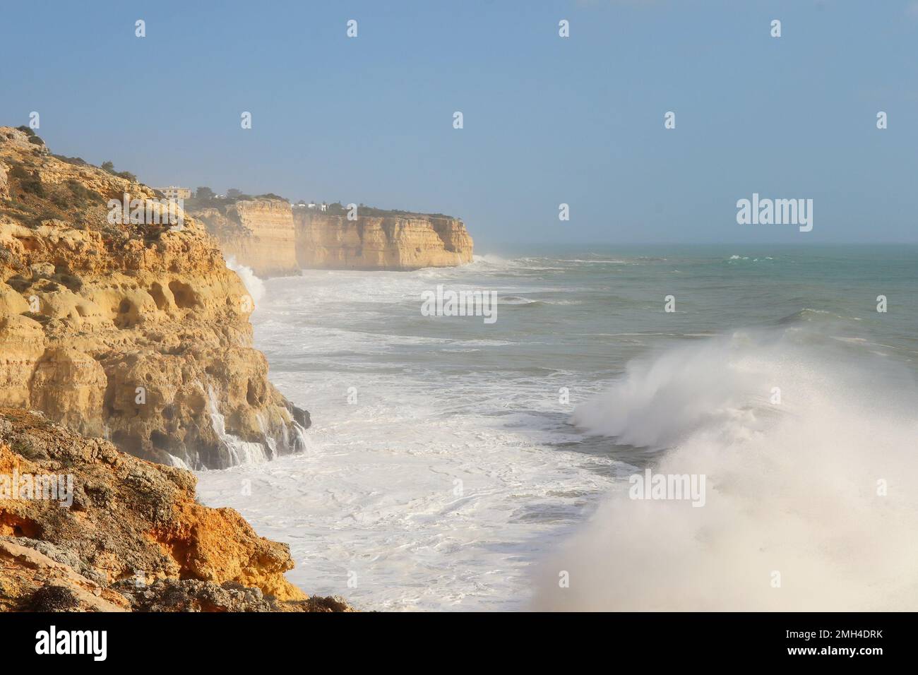 Big white wave headed toward cliffs in the Atlantic Ocean in southern ...