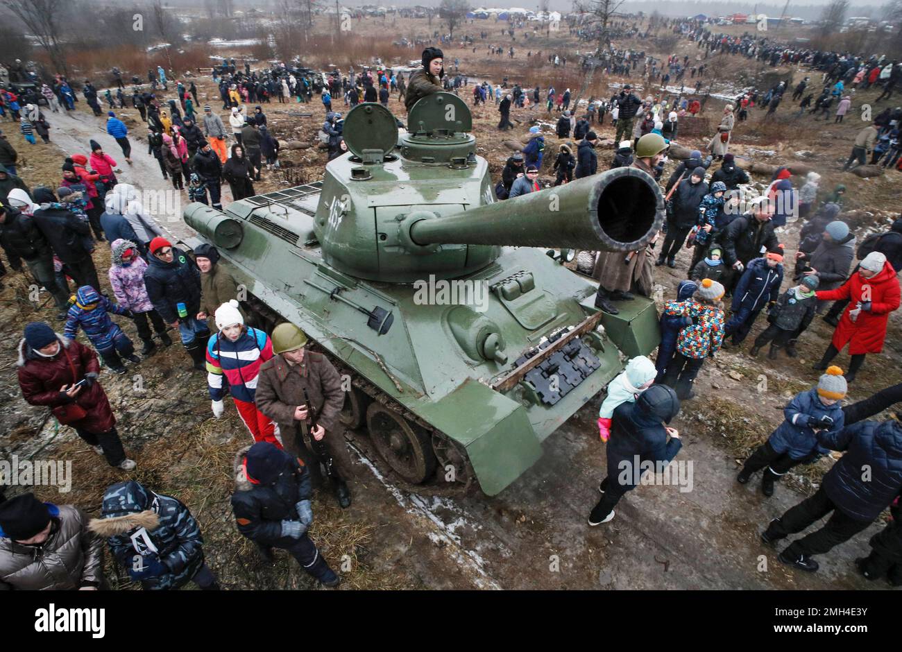 People walk around a Soviet World War II T-34 tank after a battle ...