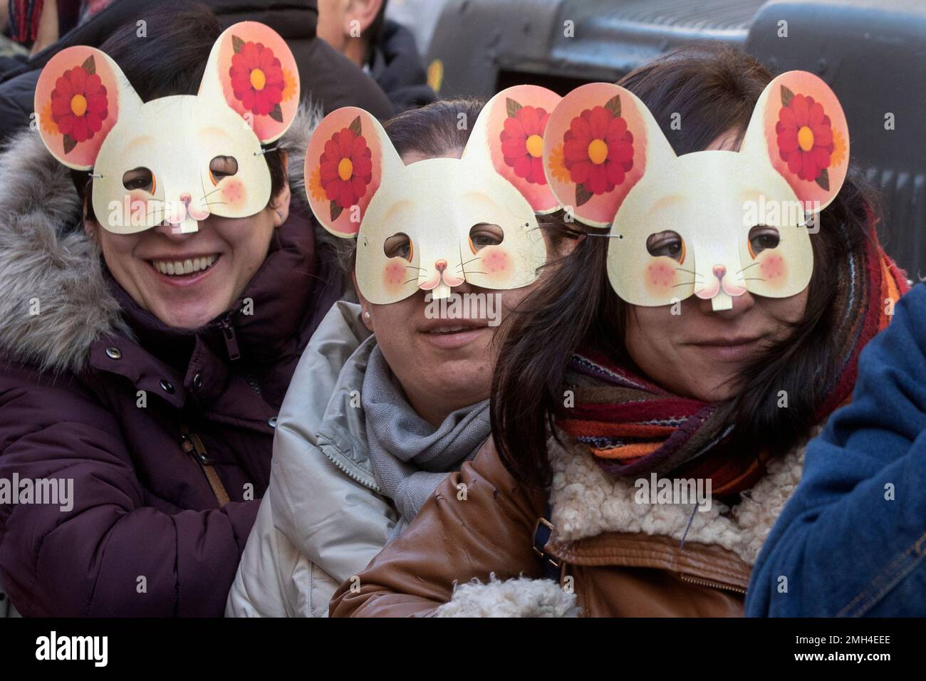 Spectators wearing Rat masks watch the parade during the celebrations ...