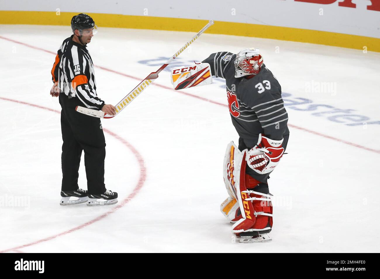 Calgary Flames goalie David Rittich (33) retrieves his stick in the NHL ...