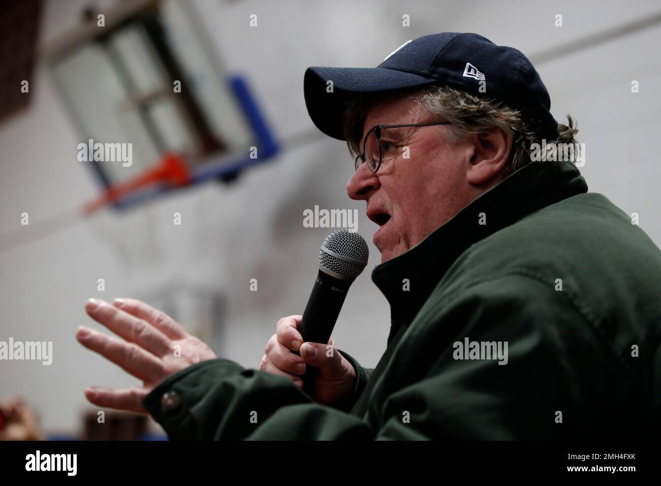 Filmmaker Michael Moore speaks to the overflow crowd before a rally for ...