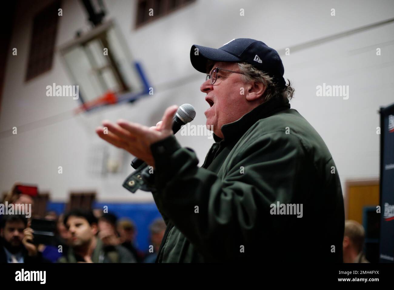 Filmmaker Michael Moore speaks to the overflow crowd before a rally for ...