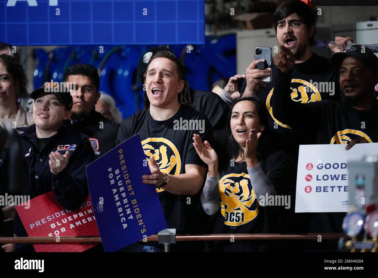 People cheer as President Joe Biden speaks at the Steamfitters Local ...