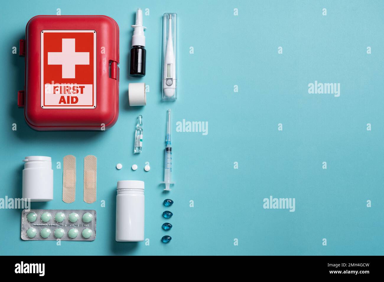 Home first aid kit on a blue background. The elements of the first aid ...