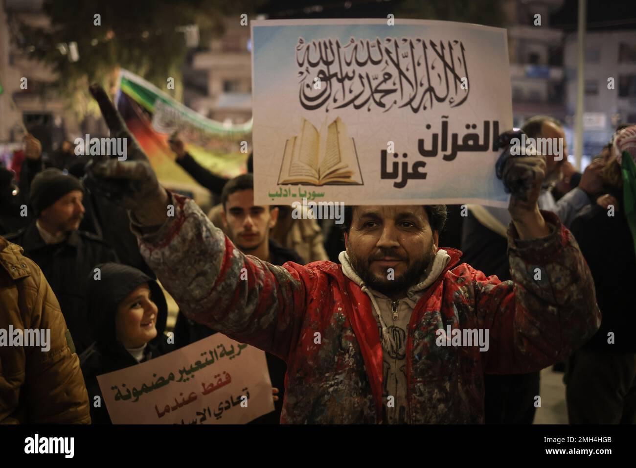 Idlib City, Syria. 26th Jan, 2023. Syrians hold placards during a ...