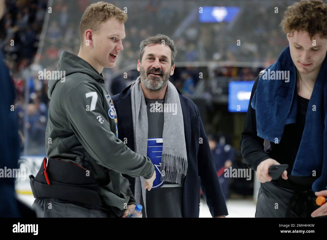 Actor Jon Hamm, center, greets Ottawa Senators forward Brady Tkachuk ...