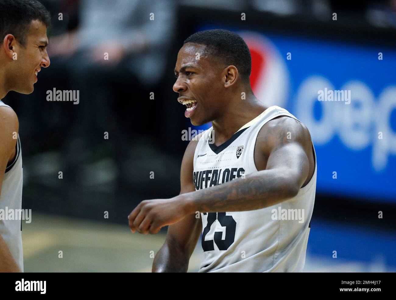 Colorado guard McKinley Wright IV, right, reacts after hitting a basket ...