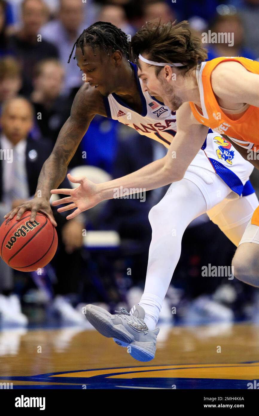 Kansas guard Marcus Garrett (0) gets past Tennessee forward John ...