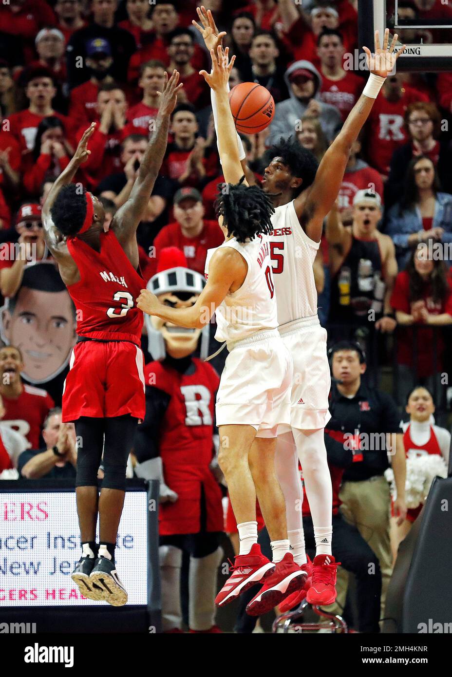 Nebraska guard Cam Mack (3) has his shot blocked by Rutgers guard Geo ...