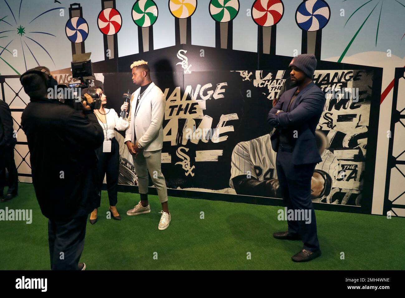 Chicago White Sox's Luis Robert, left, is interviewed as Jose Abreu ...