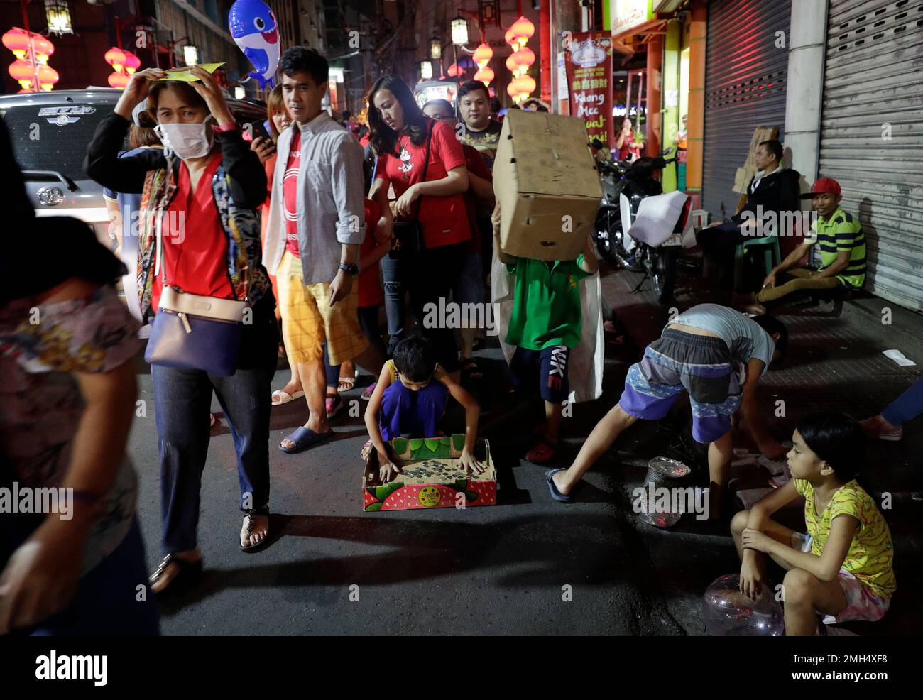 Filipino boys use a box as they perform the lion dance in Manila's ...