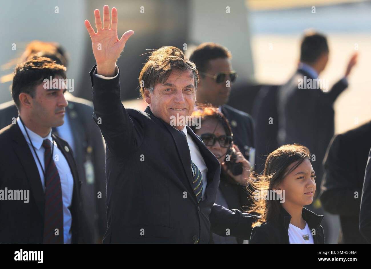 Brazil's President Jair Bolsonaro waves as he arrives with his daughter ...