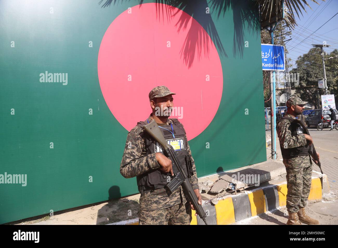 Security personnel stand guard outside the Gaddafi Stadium in Lahore ...