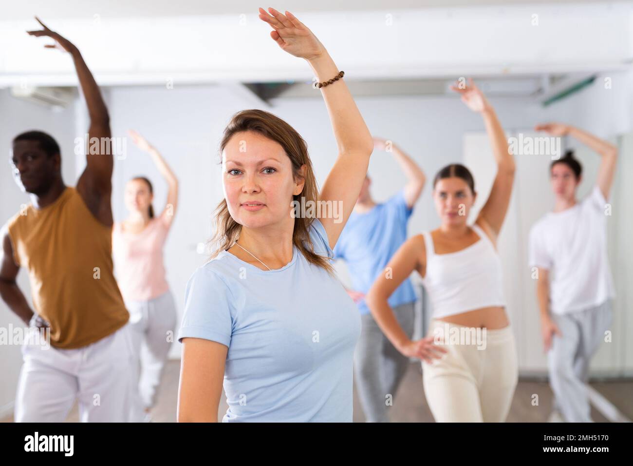 Excited positive diverse men and women of different ages stretching ...