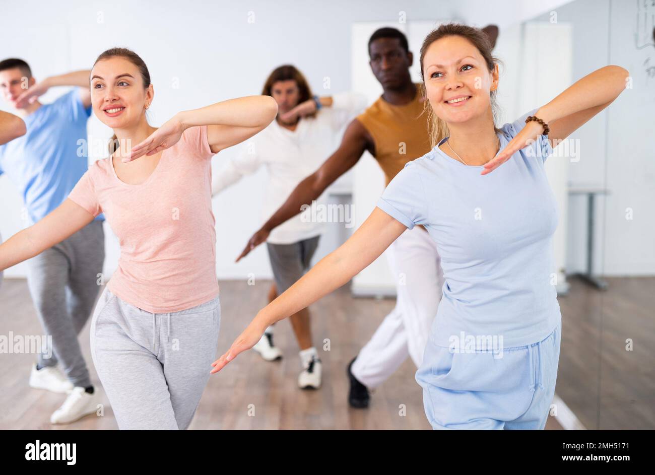 Group of different people rehearsing dance in dance studio Stock Photo ...