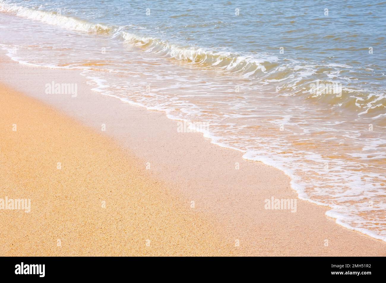 The coast of the Sea of Azov. Sea waves roll on the sandy shore ...