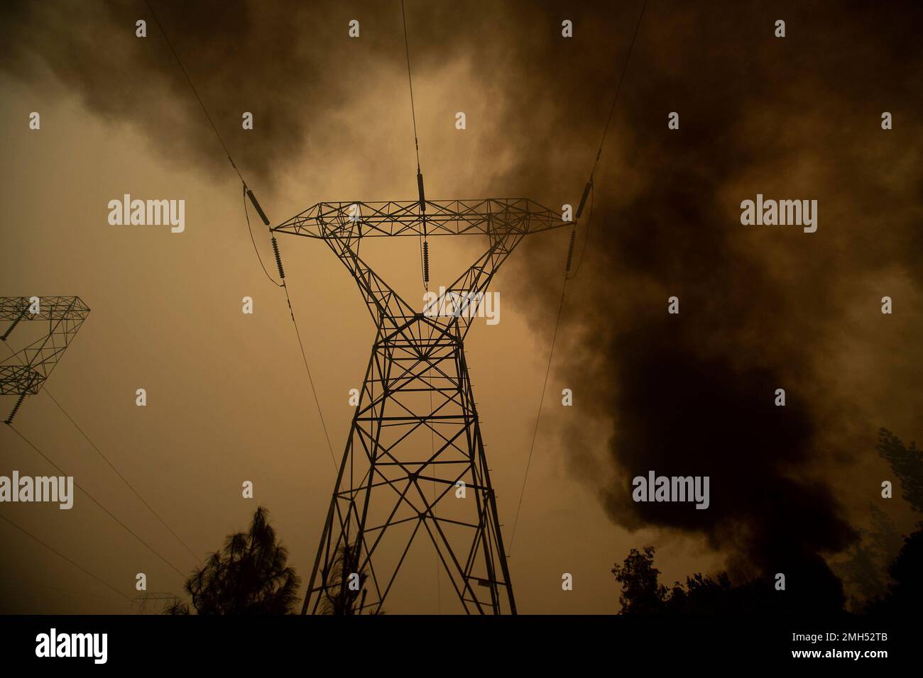 FILE - In this Nov. 9, 2018, file photo, smoke billows around power ...