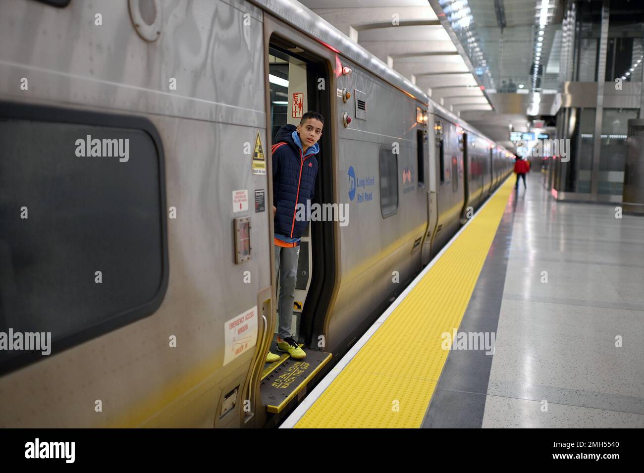 New York, USA . 26th Jan, 2023. A young person looks out the door of a ...