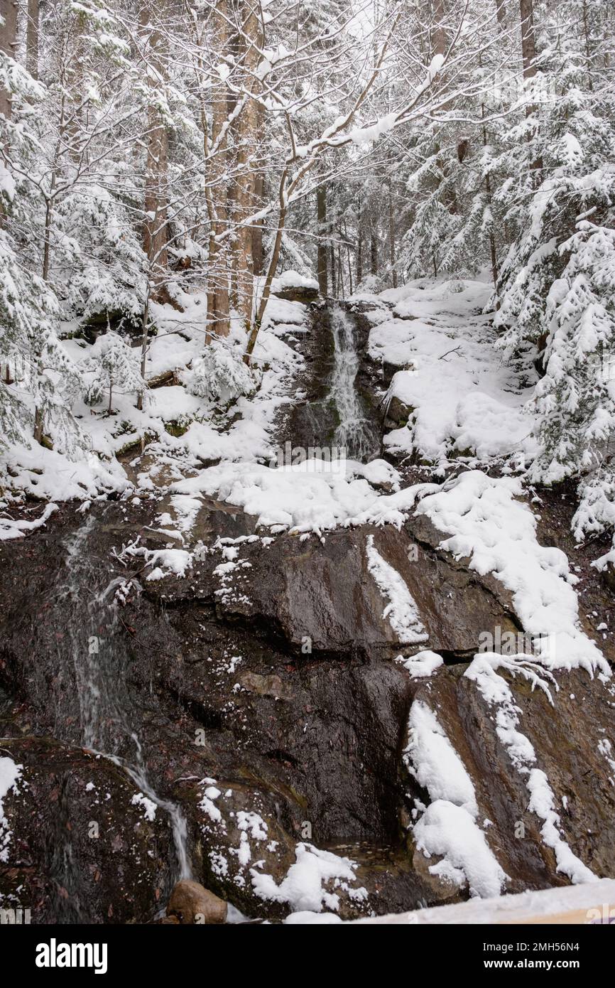 Snow covered river and waterfall with mountains in winter Stock Photo ...