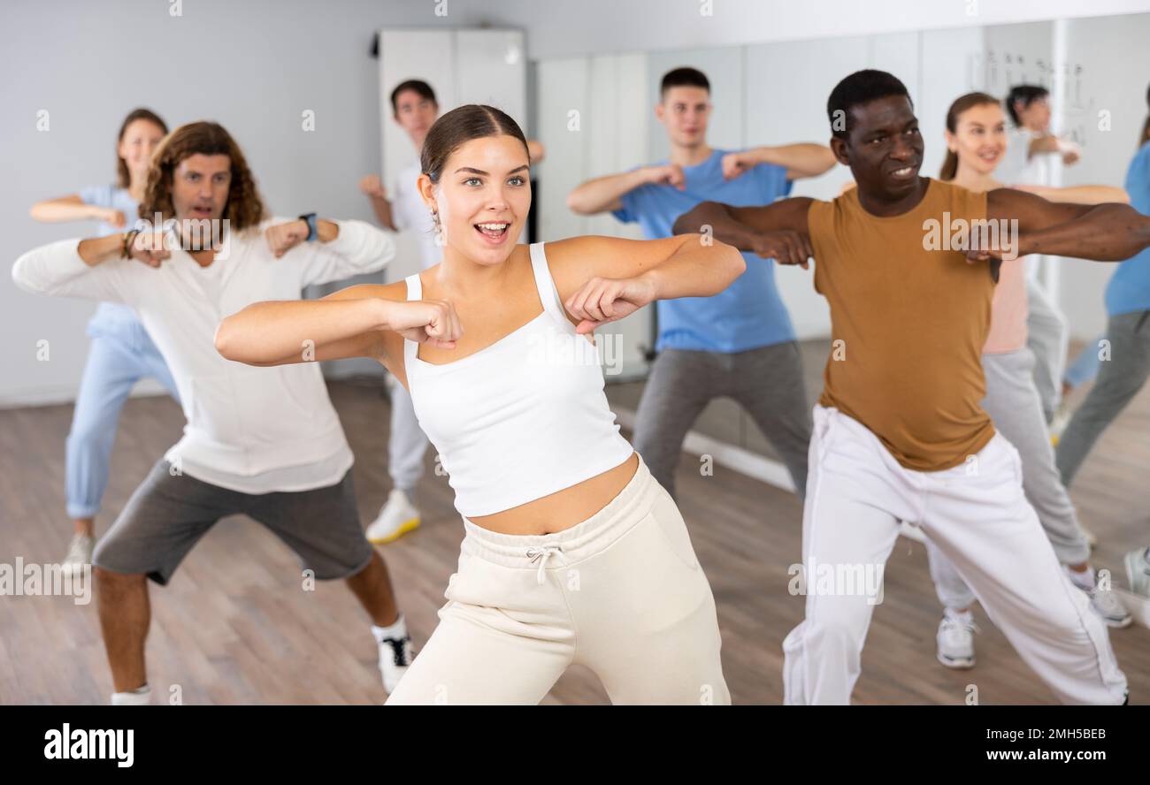 Group of different people rehearsing dance in dance studio Stock Photo ...