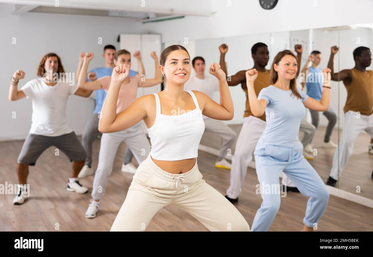 Group of different people rehearsing dance in dance studio Stock Photo ...