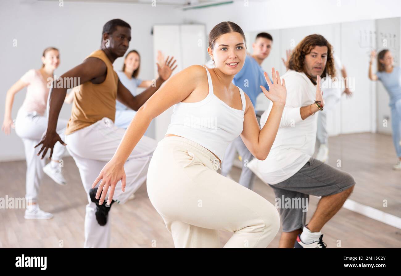 Group of different people rehearsing dance in dance studio Stock Photo ...