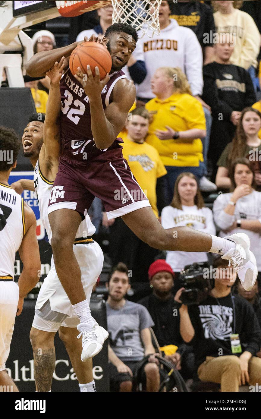 Texas A&M's Josh Nebo, right, pulls down a rebound in front of Missouri ...