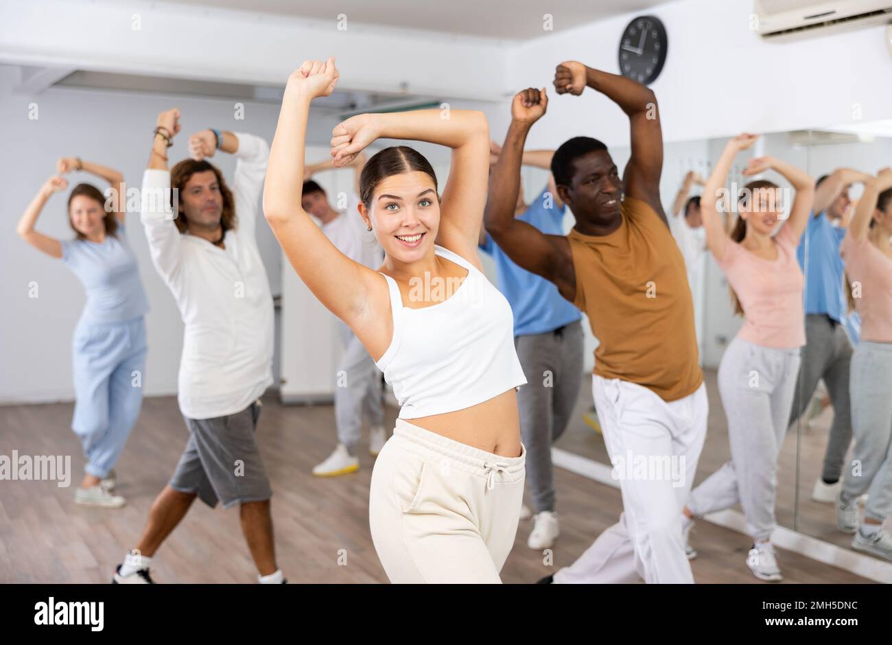 Group of different people rehearsing dance in dance studio Stock Photo ...