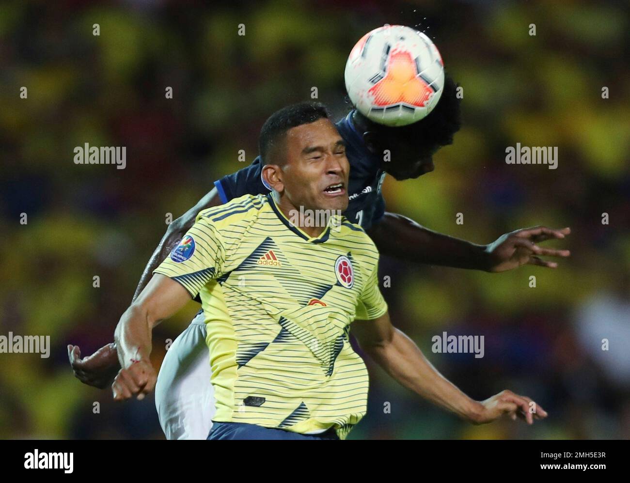 Colombia's Eddie Segura, left, and Ecuador's Jackson Porozo jump for a ...
