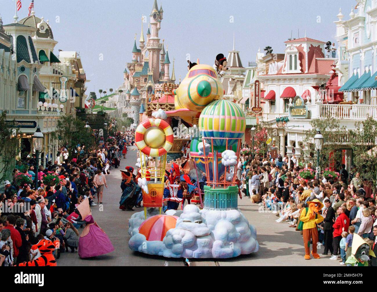 Mickey Mouse waves to the crowd from a plane atop his float as a parade ...