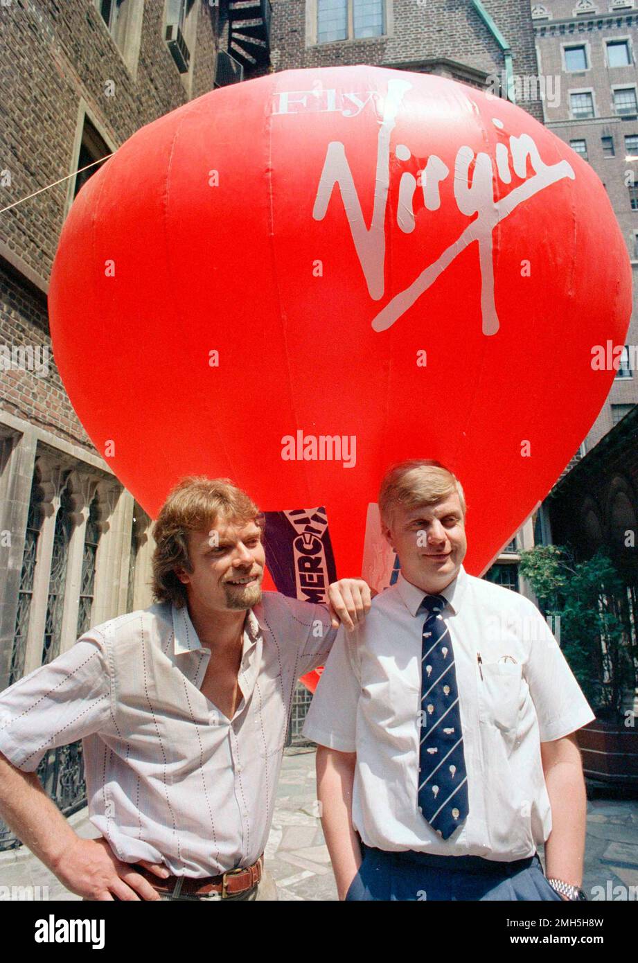 British tycoon Richard Branson, right, shakes hands with his co-pilot ...