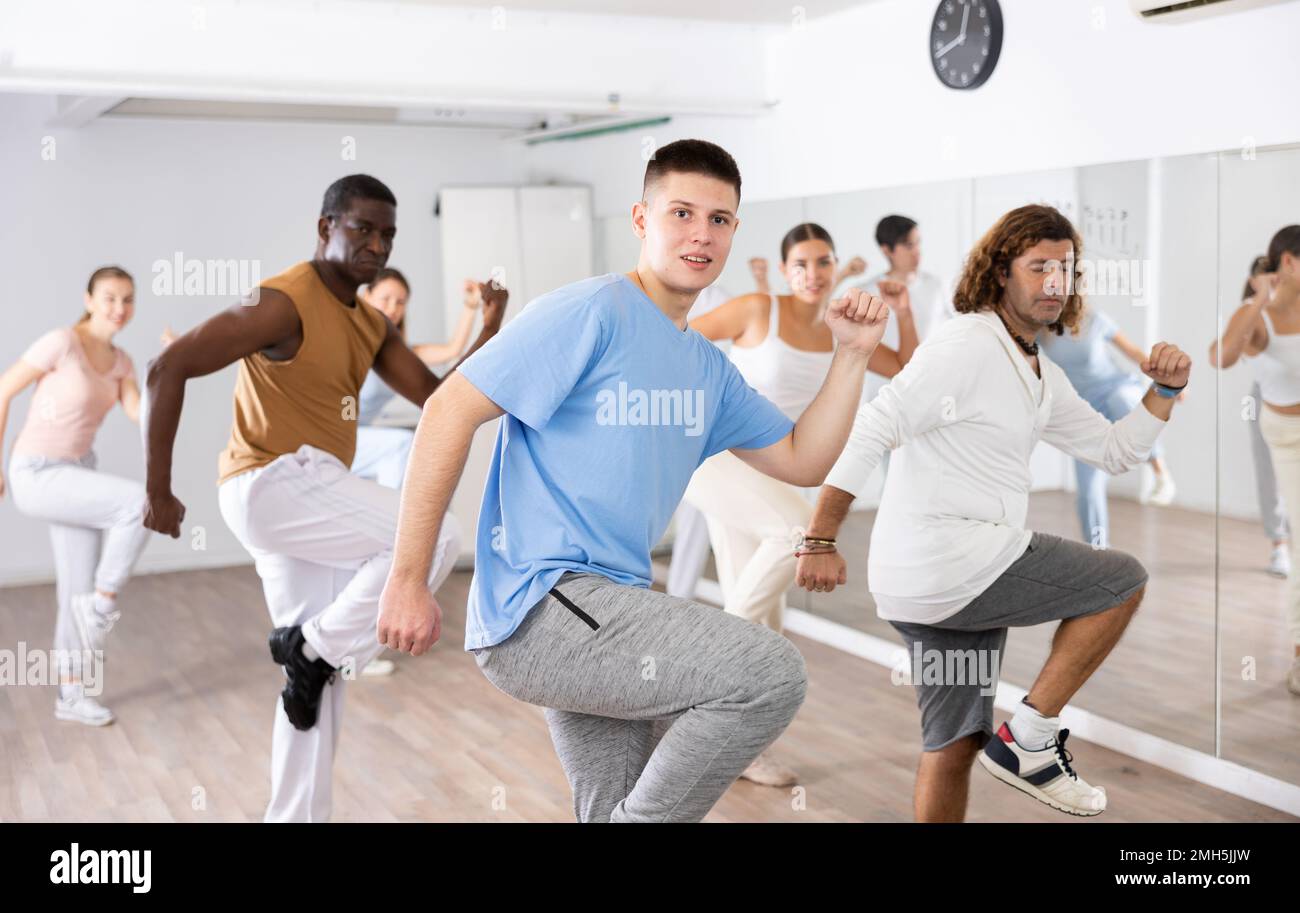 Group of multinational happy adult people enjoying active dance ...
