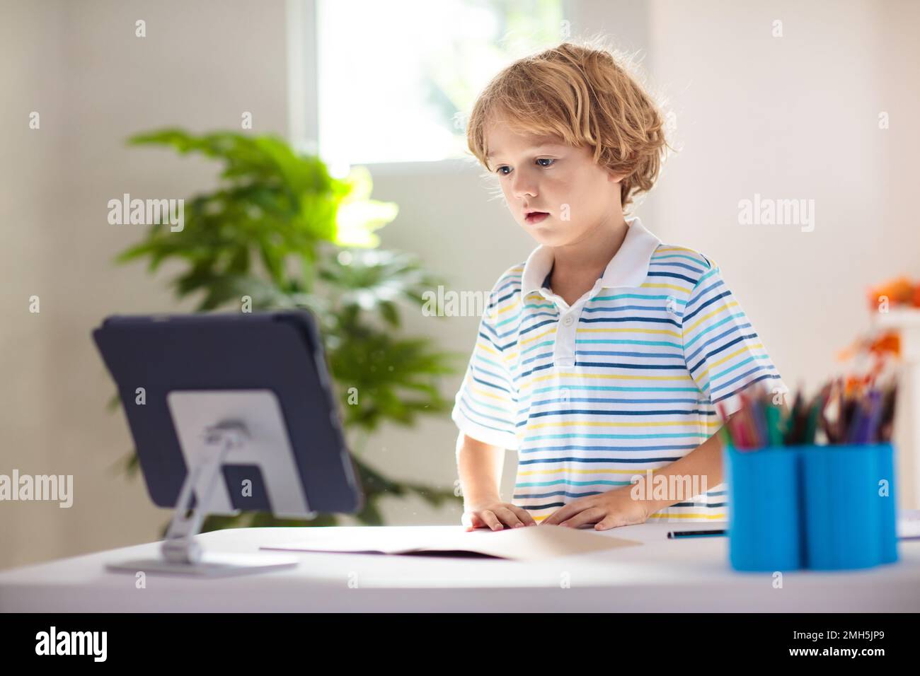 Online remote learning. School kids with computer having video ...