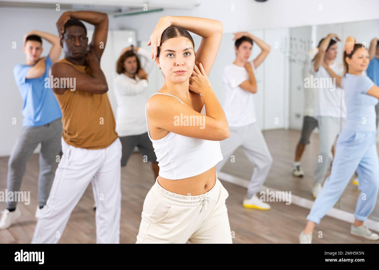 Group of different people rehearsing dance in dance studio Stock Photo ...