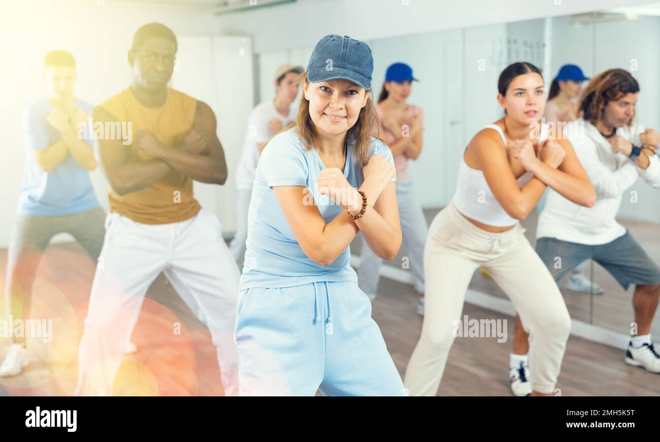 Happy multiracial men women of different ages performing dynamic ...